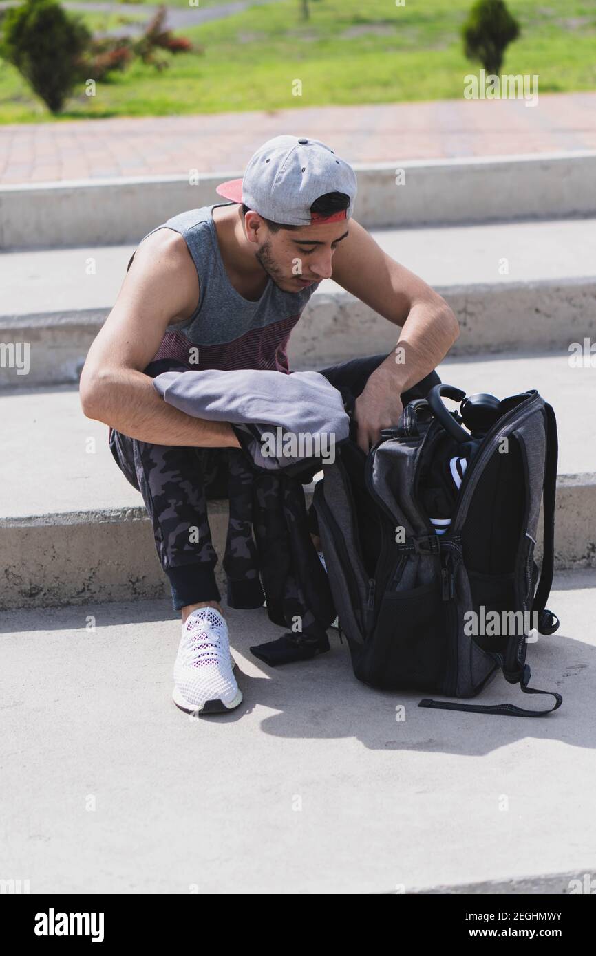 Backpack with clothes and accessories to do sports anywhere Stock Photo ...