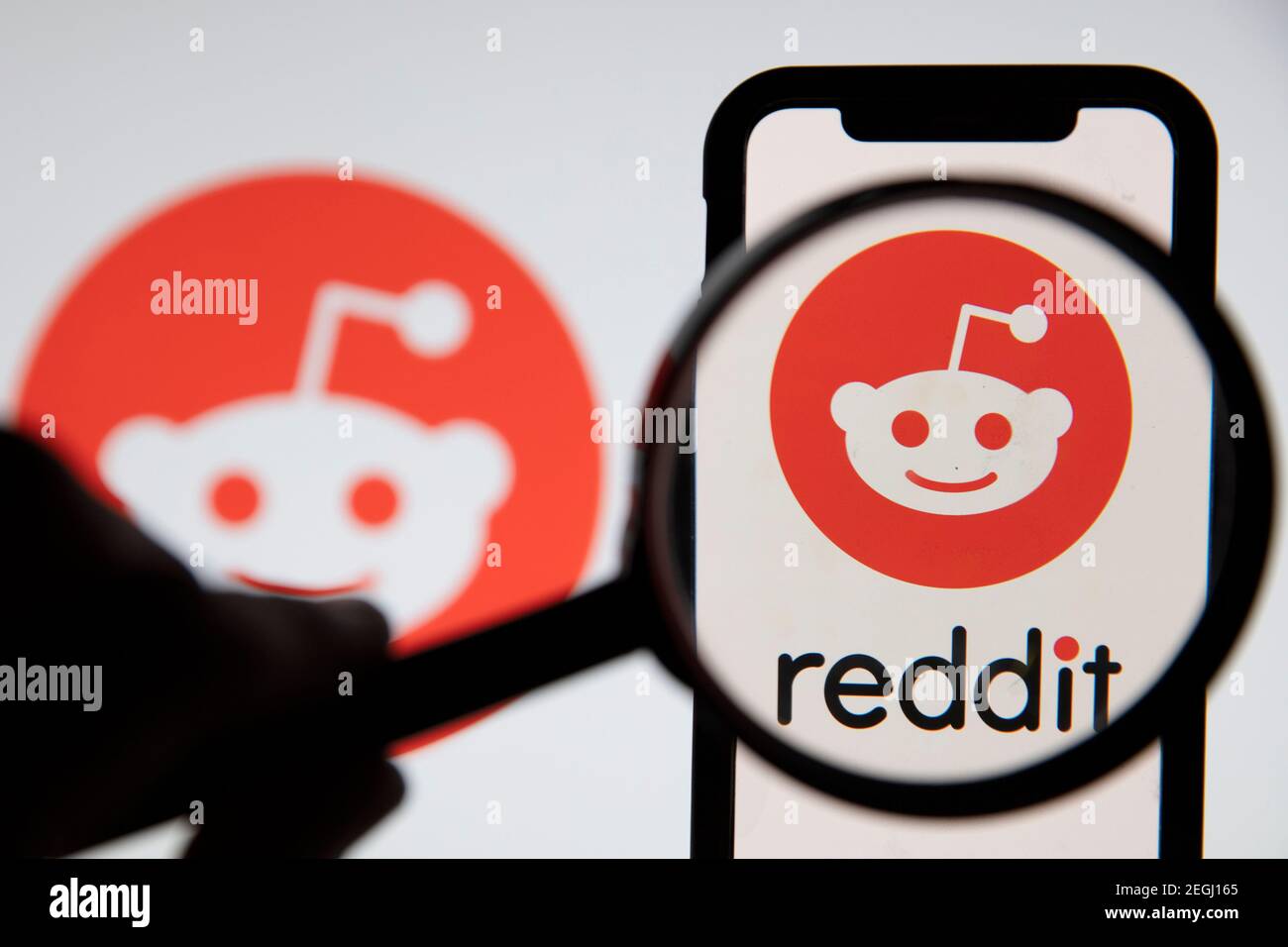 LONDON, UK - February 2021: Reddit logo seen under a magnifying glass ...
