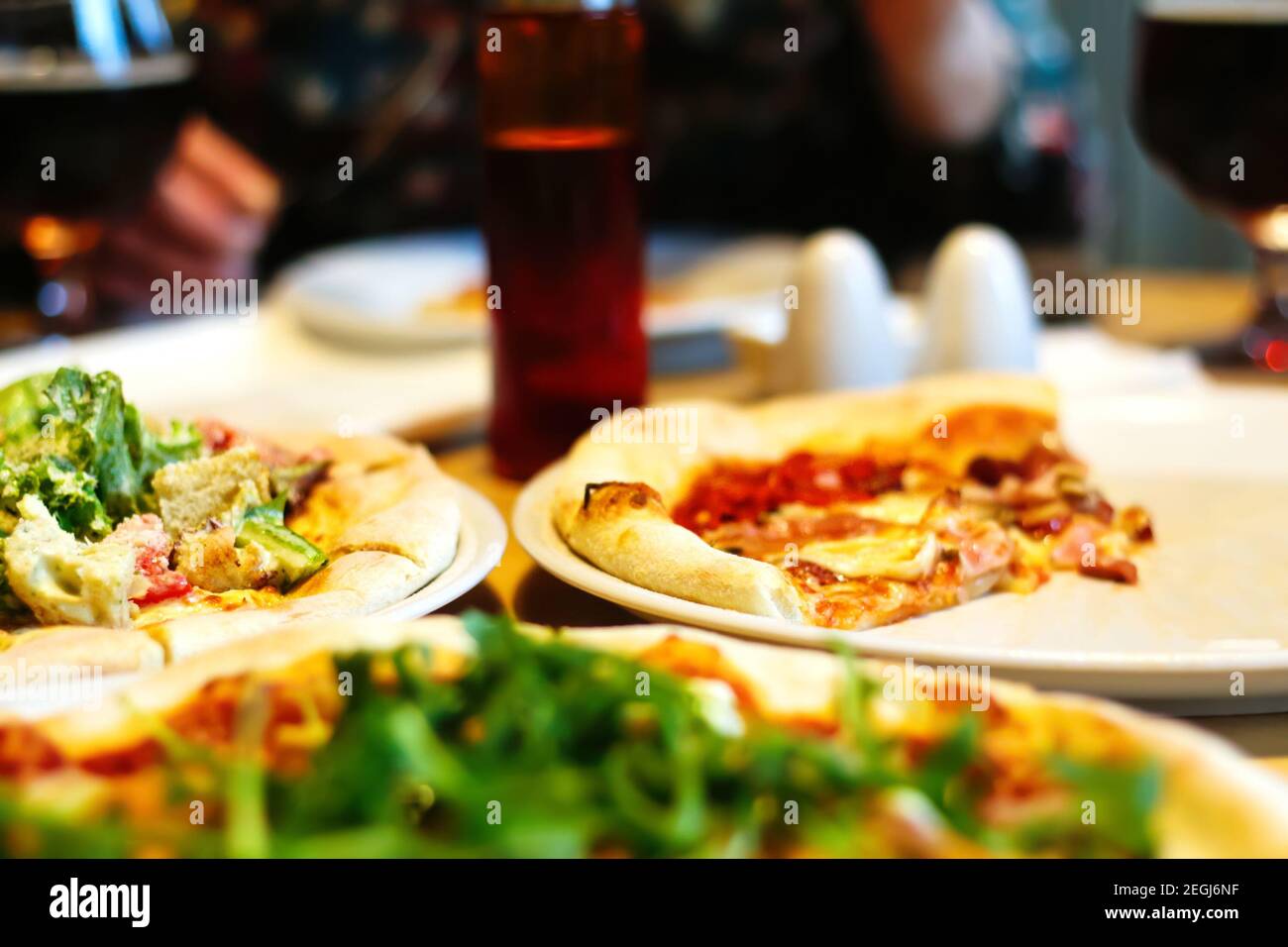 Defocus People eat pizza at a table in a cafe.A table in a cafe with ...
