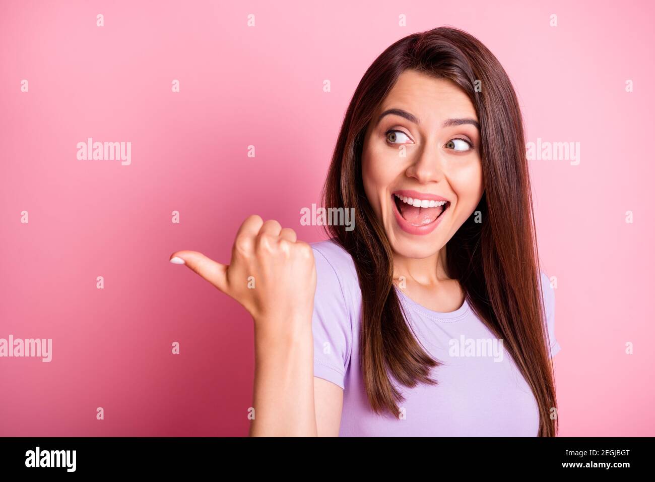 Photo portrait of impressed shocked girl smiling showing with finger on ...