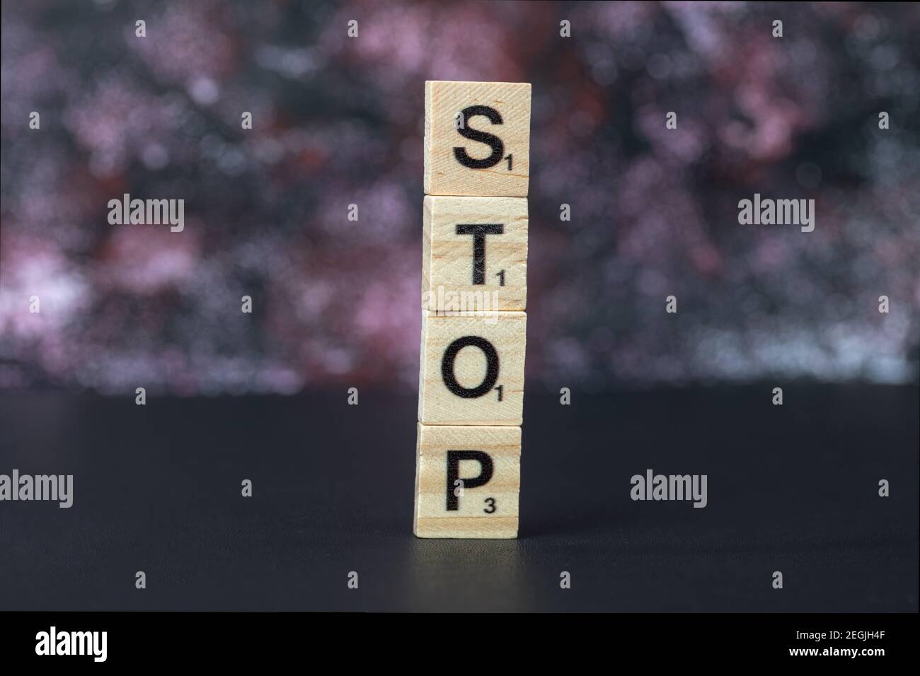 Stop symbolic writing with black letters on wooden dices in vertical ...