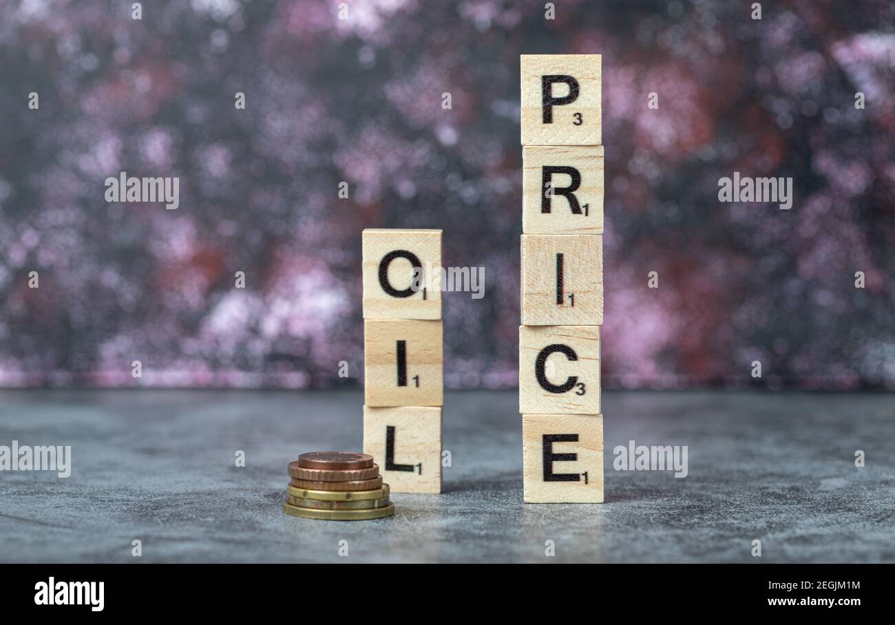 Oil price writing with black letters on wooden dices with golden coins ...
