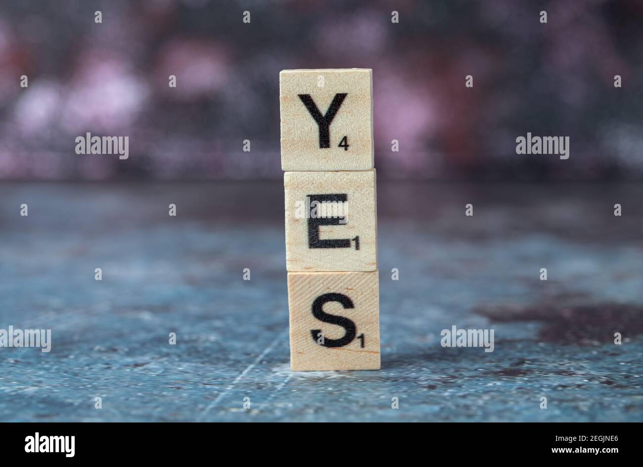 Yes symbolic writing with black letters on wooden dices in vertical ...