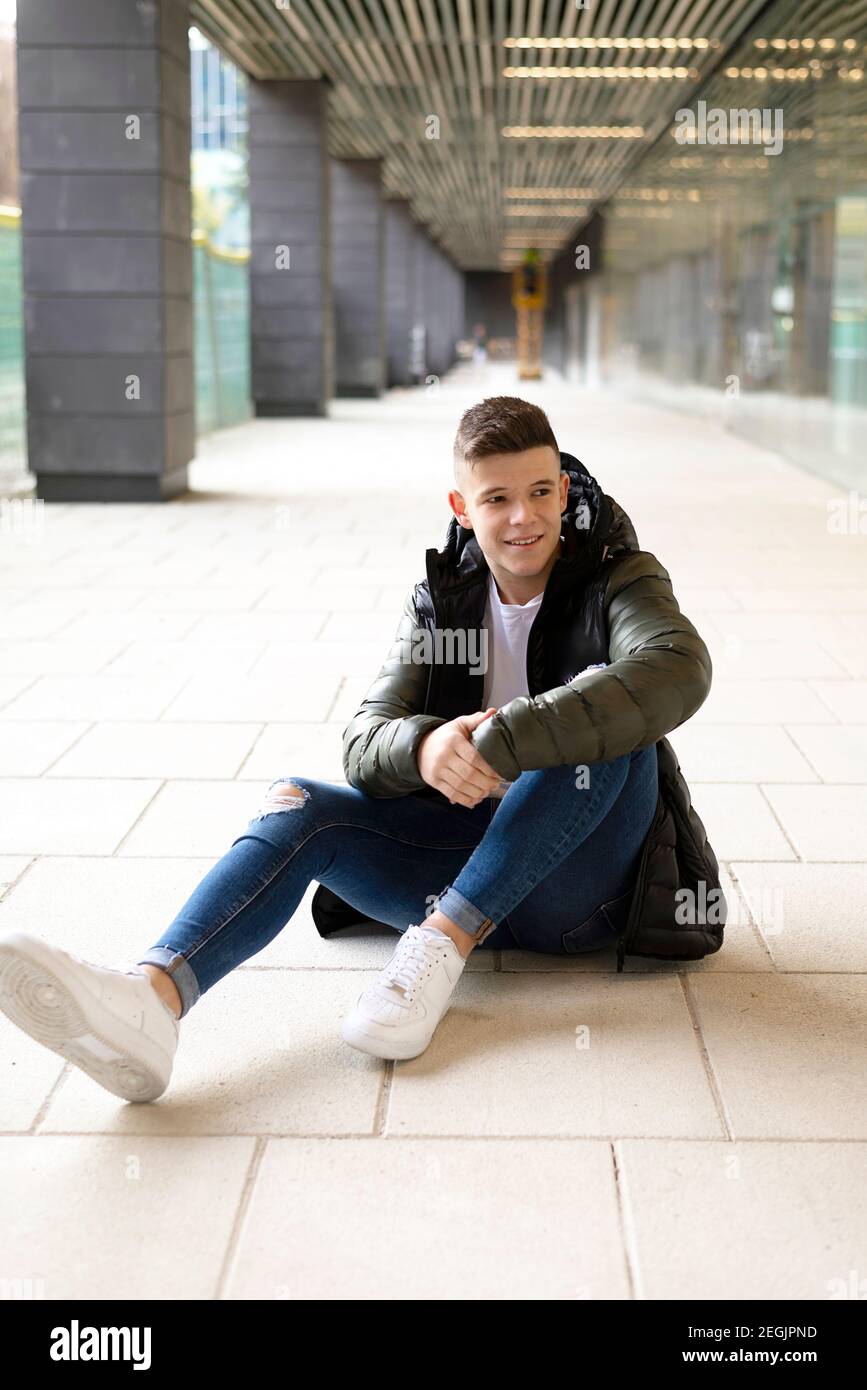 Confident man sitting on ground hi-res stock photography and images - Alamy