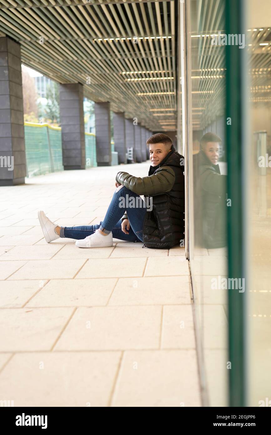 Young man sitting on ground hi-res stock photography and images - Alamy