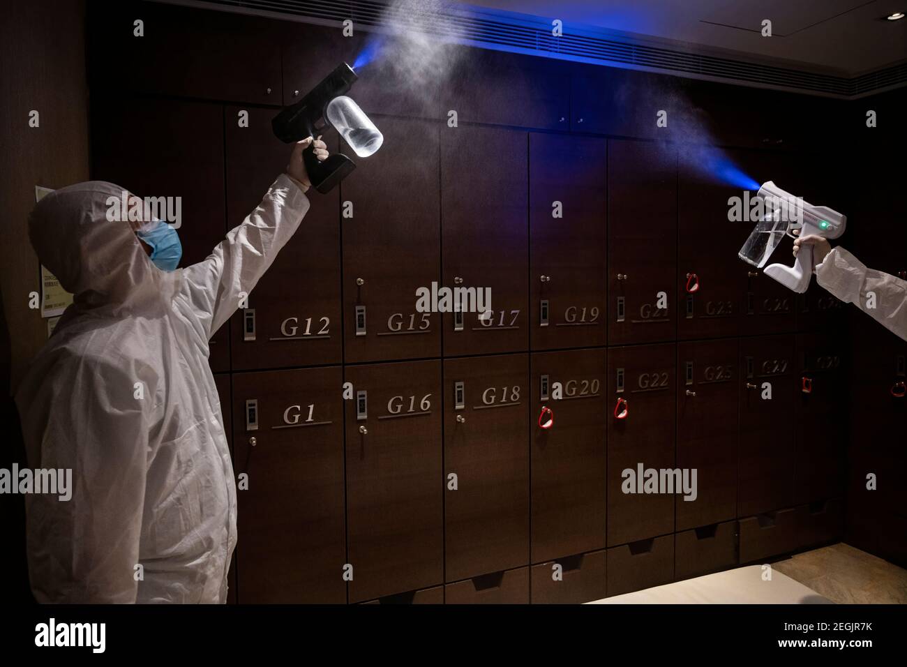 Employees wearing PPE (Personal Protective Equipment) spray ...