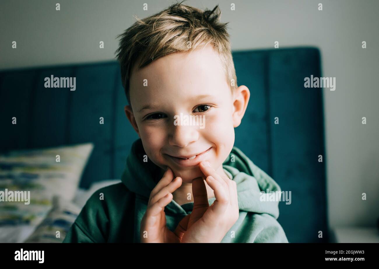 portrait of an 8 year old handsome boy smiling playfully at home Stock ...