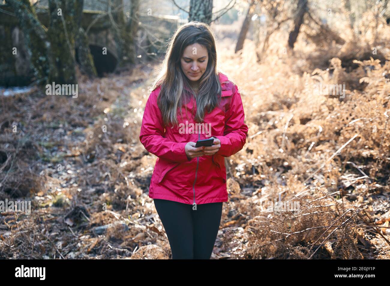 Adventurous girl consulting the route of her trekking route. Beautiful ...