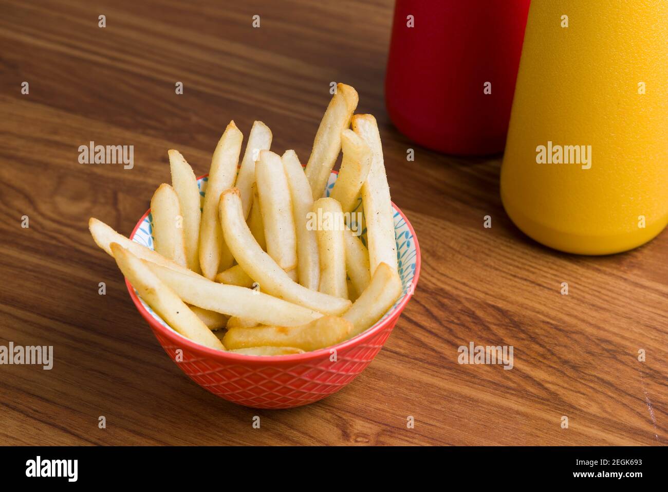 French fries side on a pink bowl Stock Photo - Alamy