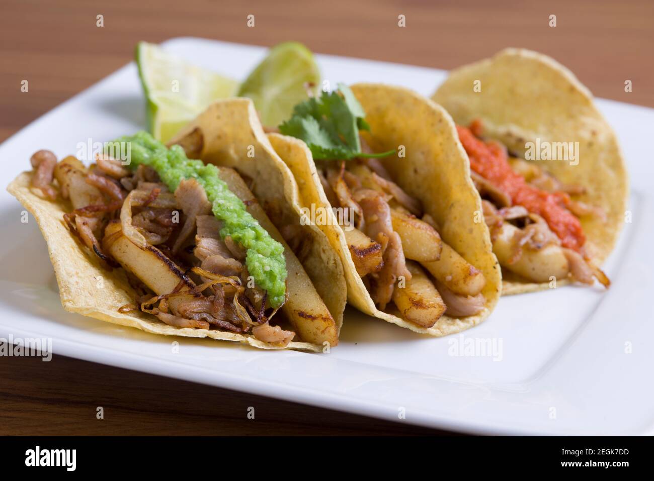 Three beef tacos with salsa and cilantro Stock Photo - Alamy
