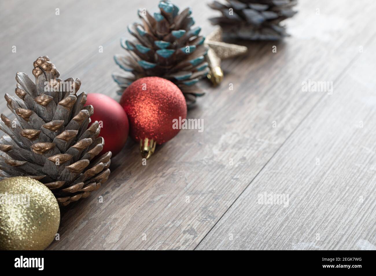 Natural oak tree cones on a wooden deck with glittering ornaments ...