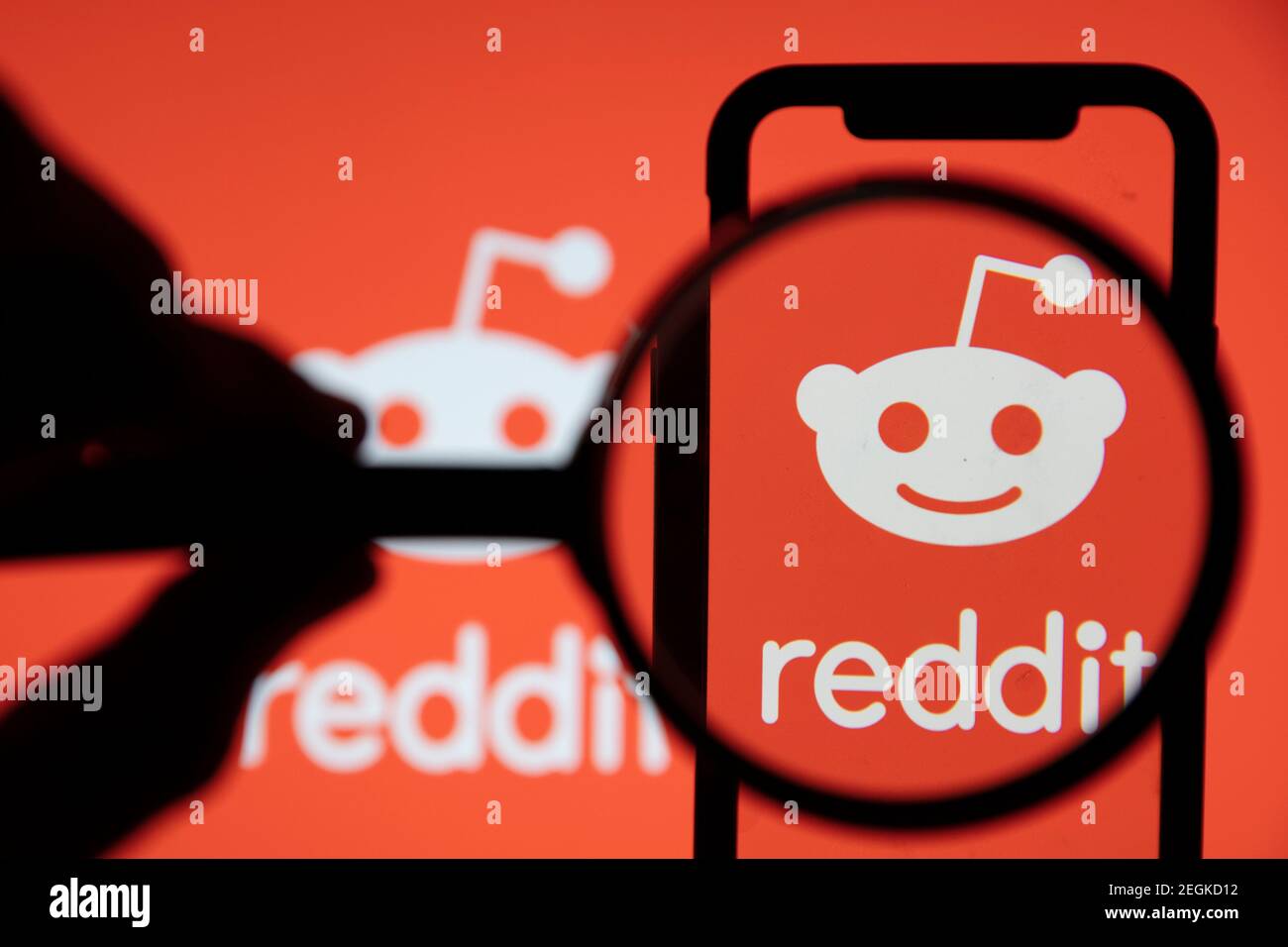 LONDON, UK - February 2021: Reddit logo seen under a magnifying glass ...