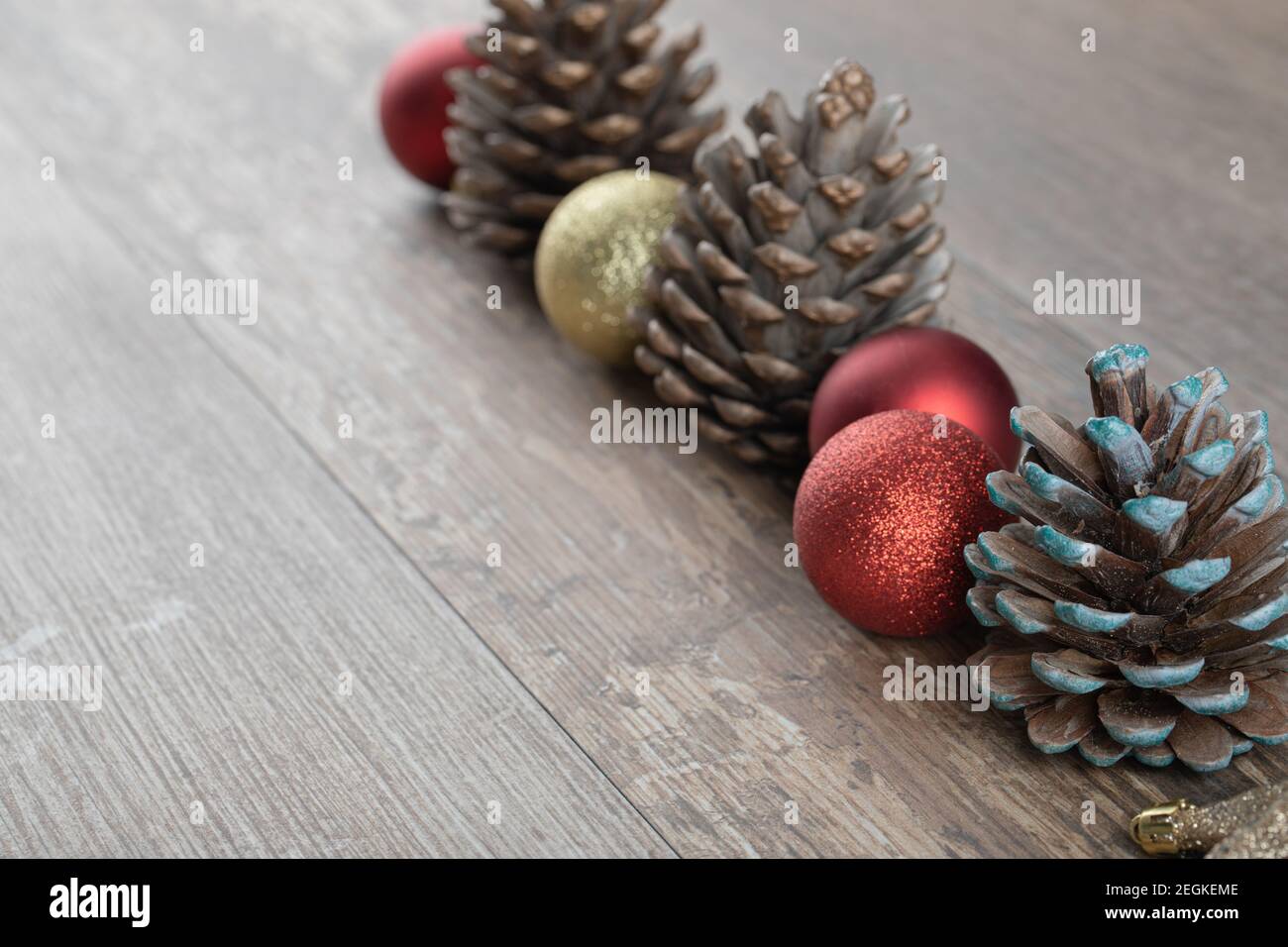 Natural oak tree cones on a wooden deck with glittering ornaments ...