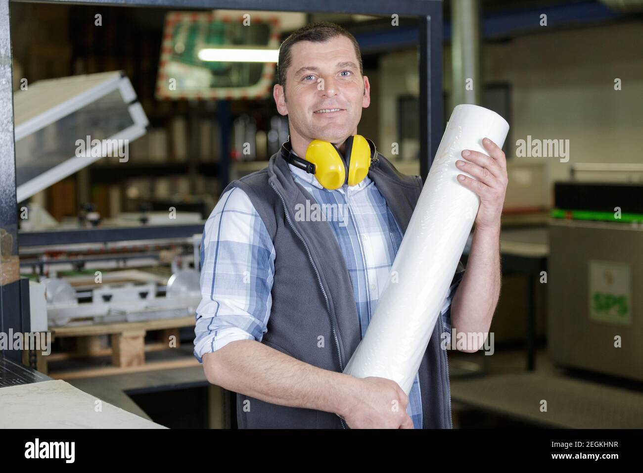 worker holding big paper roll at the packaging manufacturing Stock ...