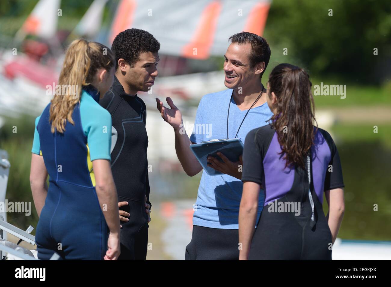 a team and stand up paddler training Stock Photo - Alamy