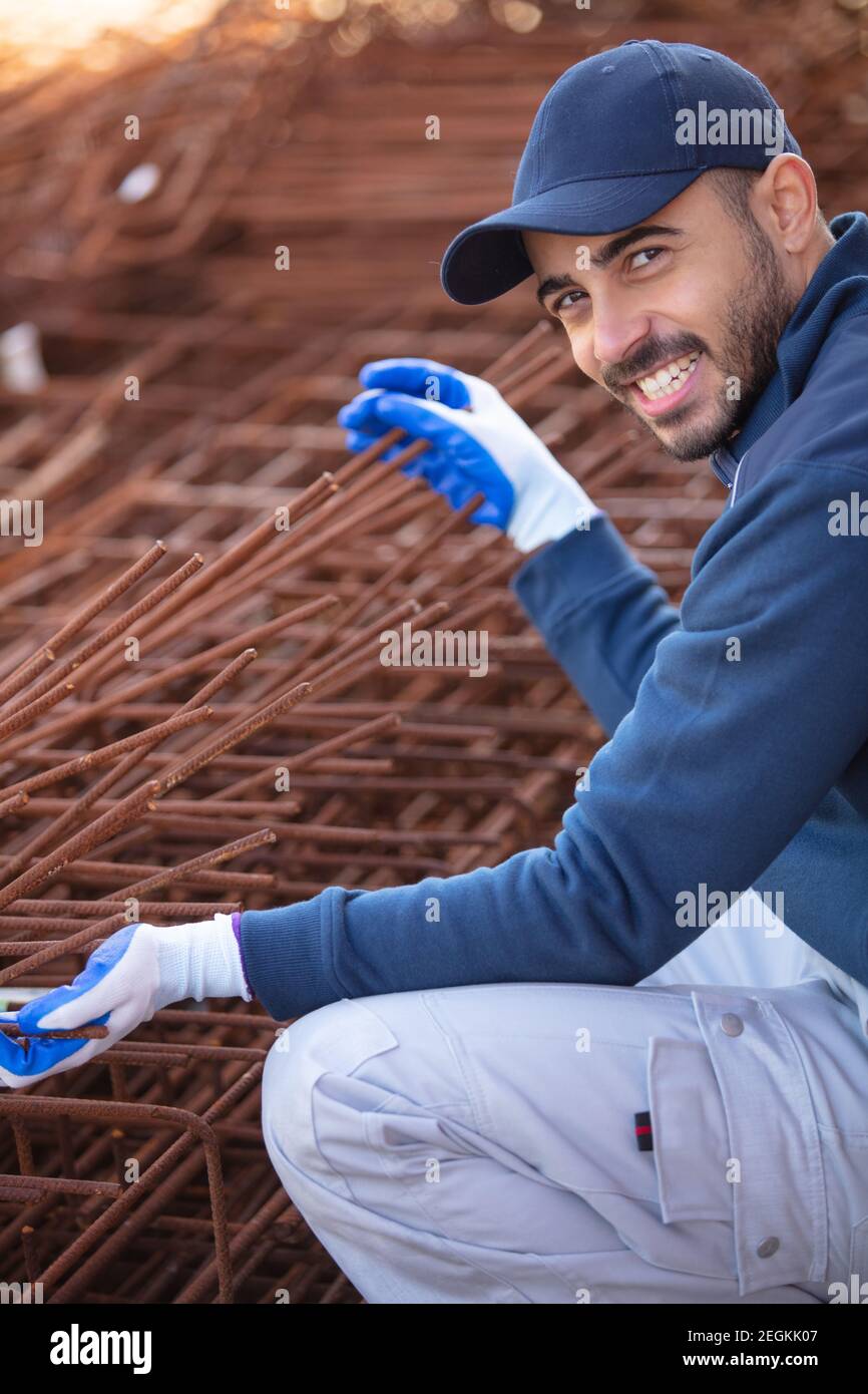 construction worker holding concrete reinforcement bars Stock Photo - Alamy
