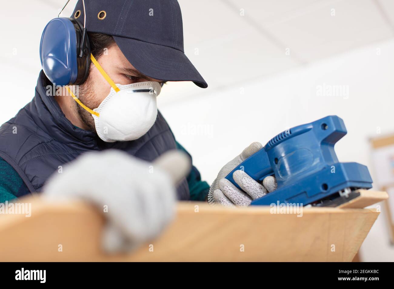 skilled carpenter cutting a piece of wood in his woodwork Stock Photo ...