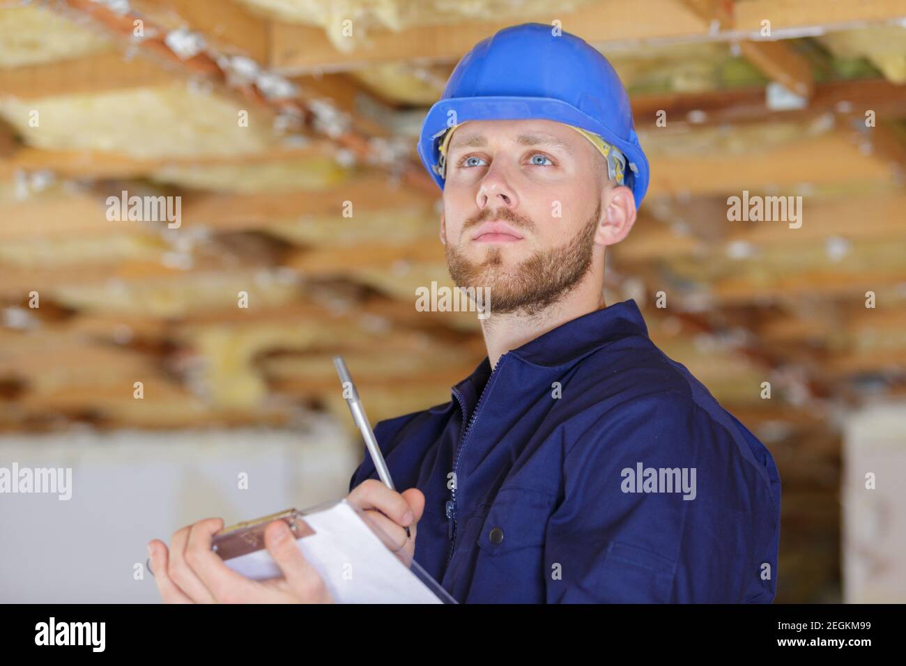 a builder with a clipboard Stock Photo - Alamy