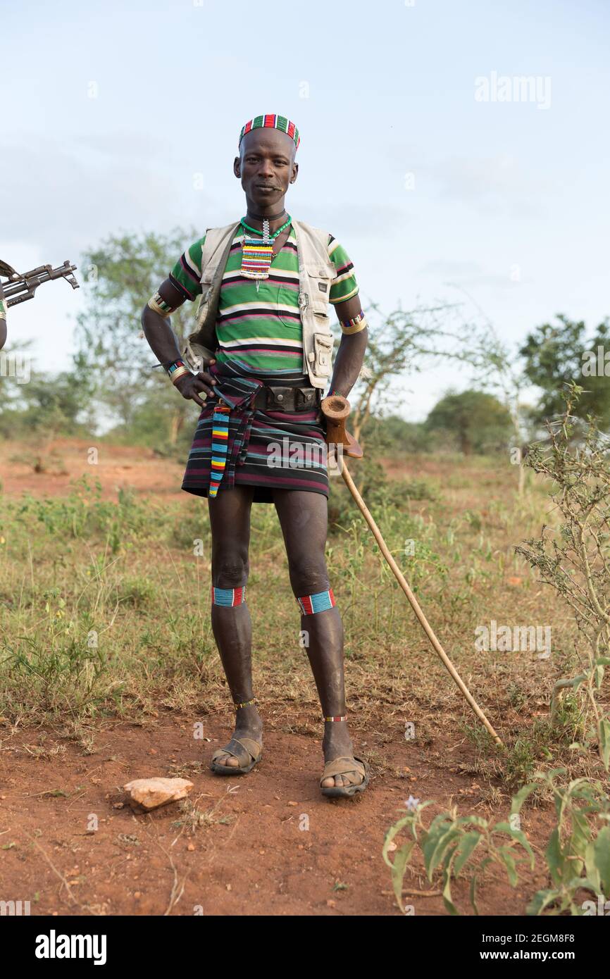 Portrait of man from the Banna tribe attending a bull jumping ceremony ...