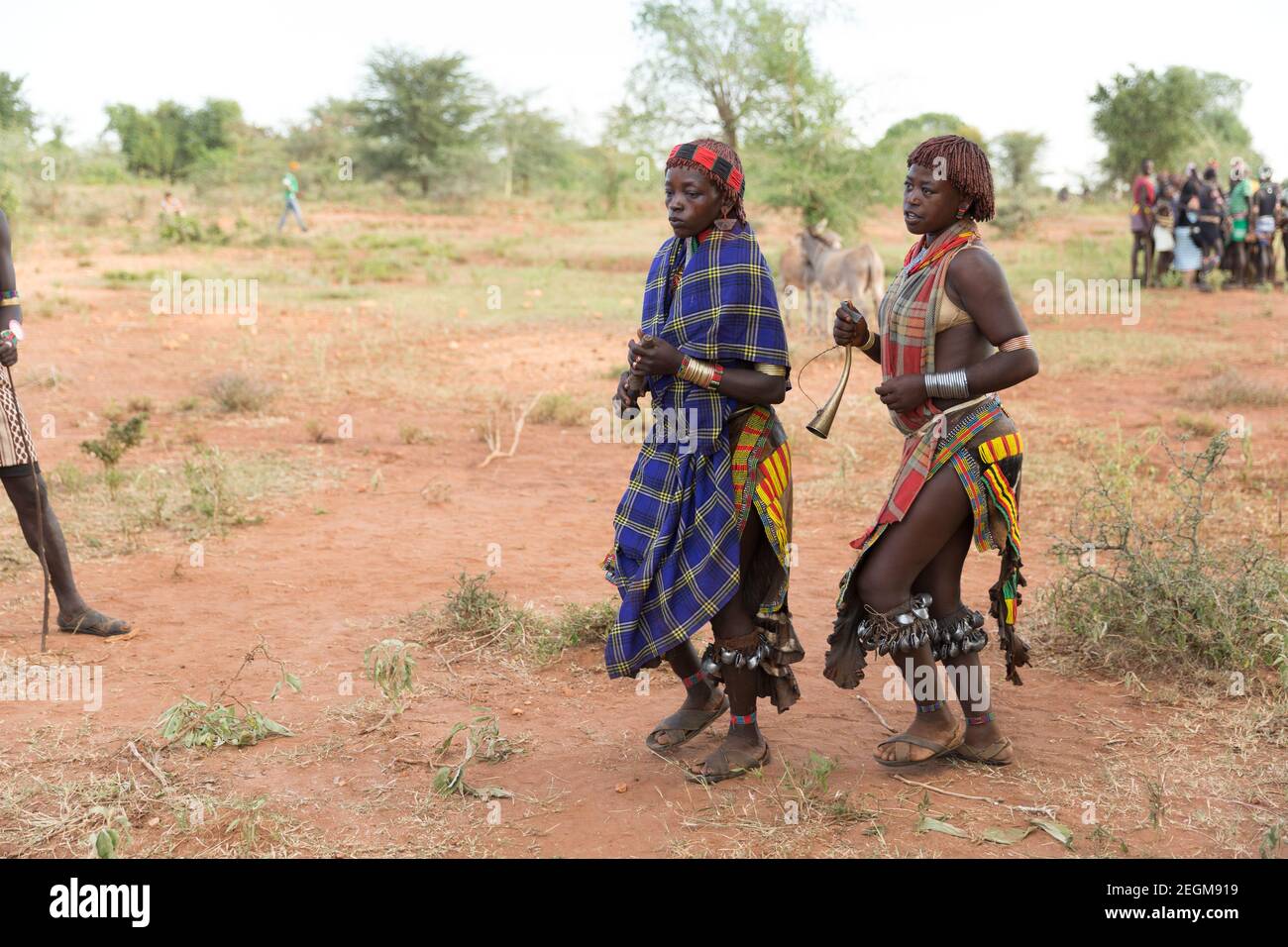 Women from the Banna tribe dancing and blowing little horns before a ...