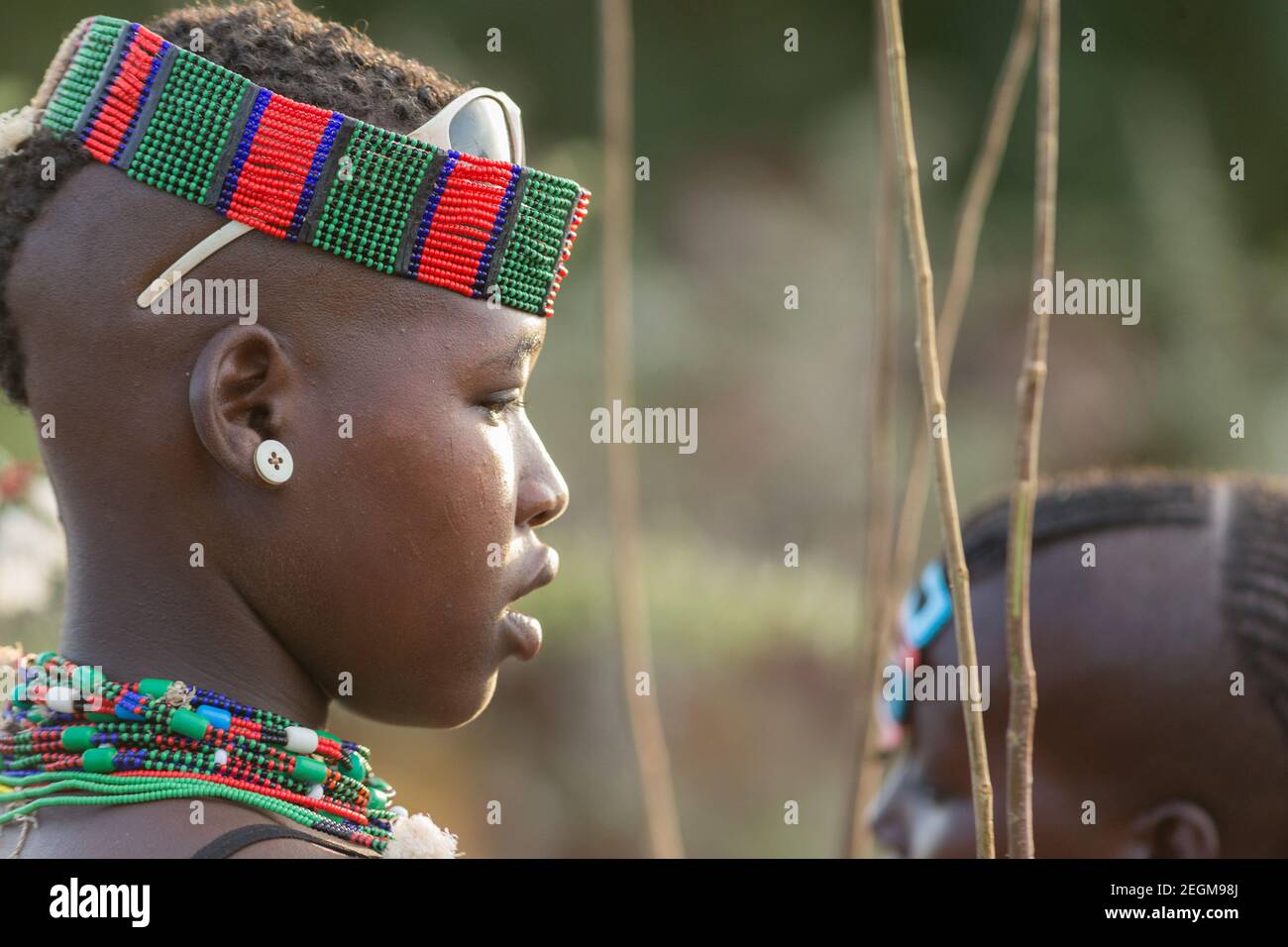 Portrait of a woman from the Banna tribe attending a bull jumping ...