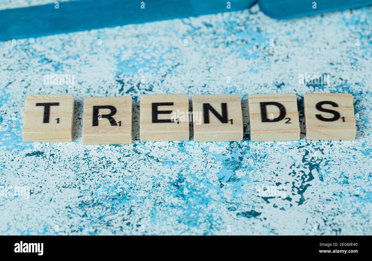 Trends writing with black letters on wooden dices on the blue ...