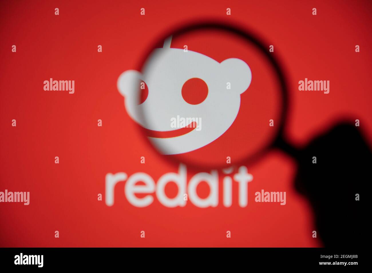 LONDON, UK - February 2021: Reddit logo seen under a magnifying glass ...