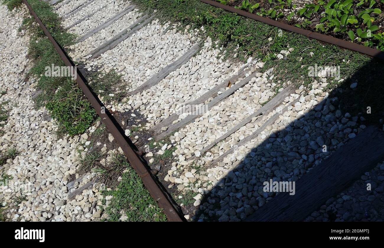 Rusting old rail tracks with vegetation growing on them and weathered ...