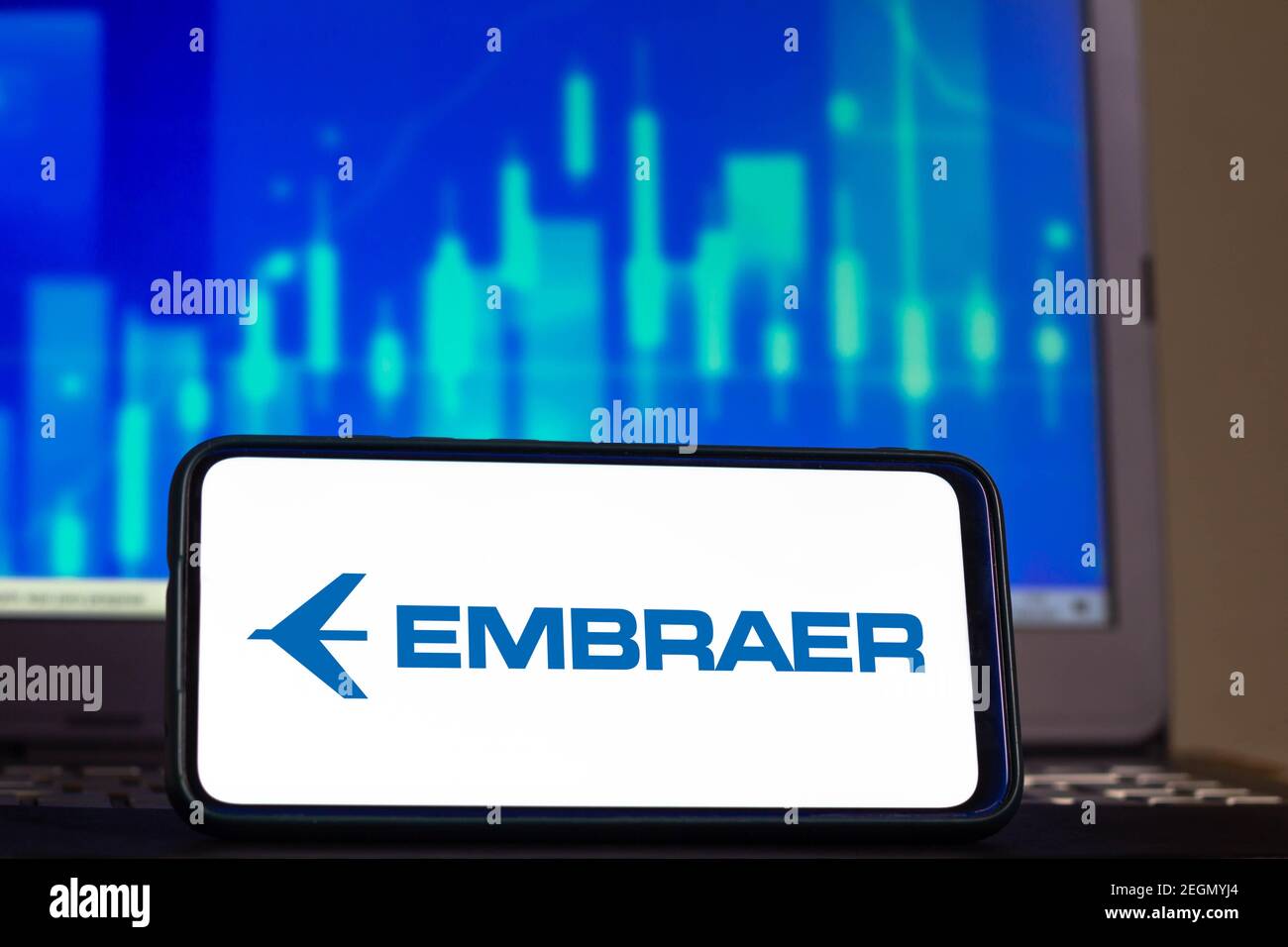 In this photo illustration an Embraer logo seen displayed on a ...