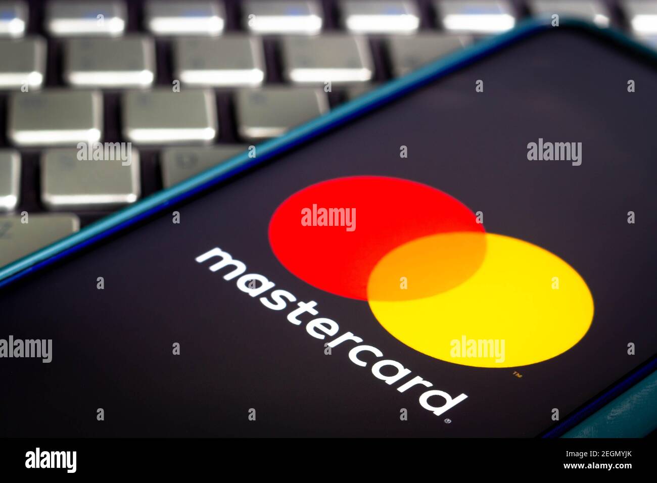 In this photo illustration a Mastercard logo seen displayed on a ...