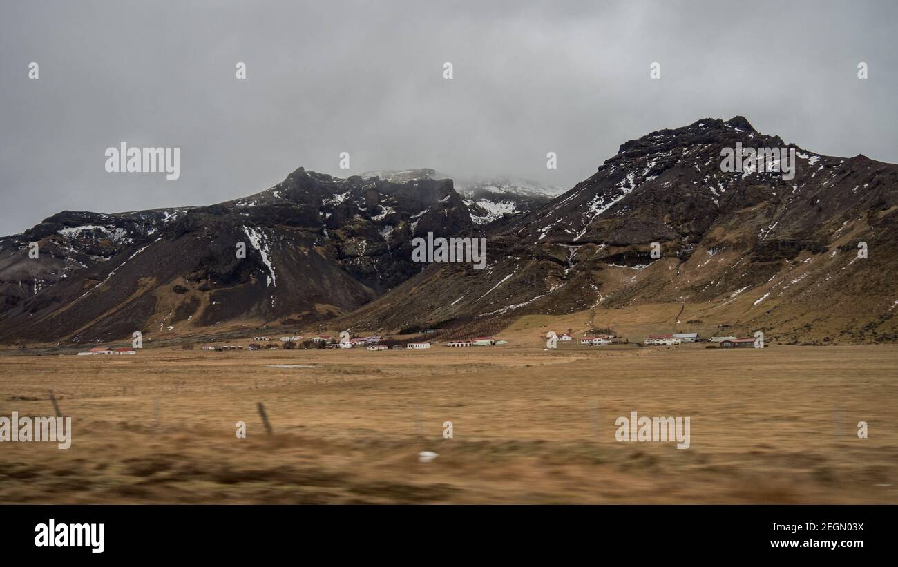 Small town at the bottom of a mountain in Iceland Stock Photo - Alamy