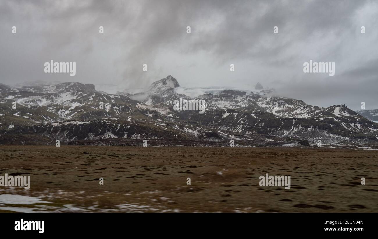 Snow covered mountains in Iceland with glacier on top Stock Photo - Alamy
