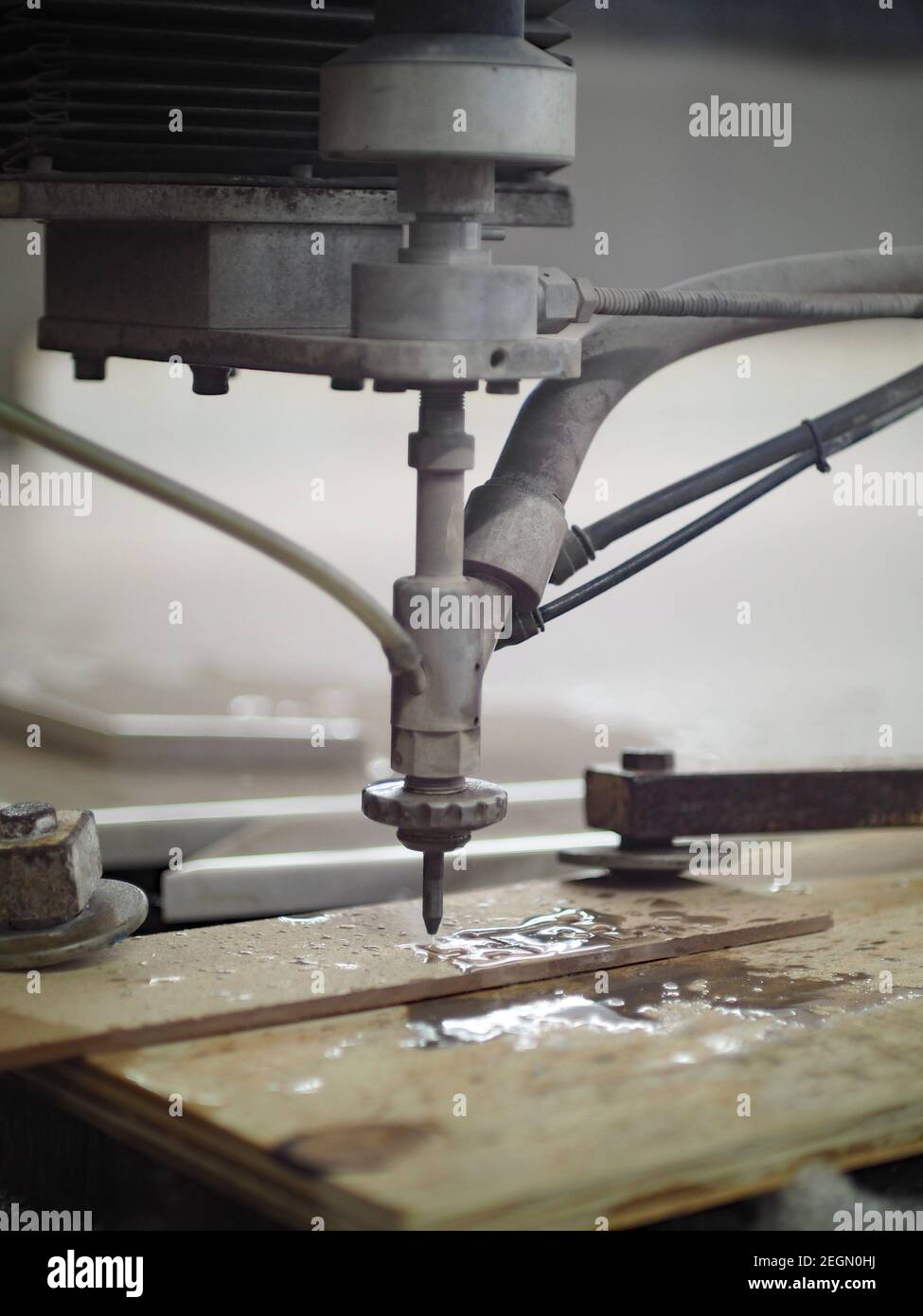 High pressure waterjet cutting acrylic, the acrylic is supported by ...