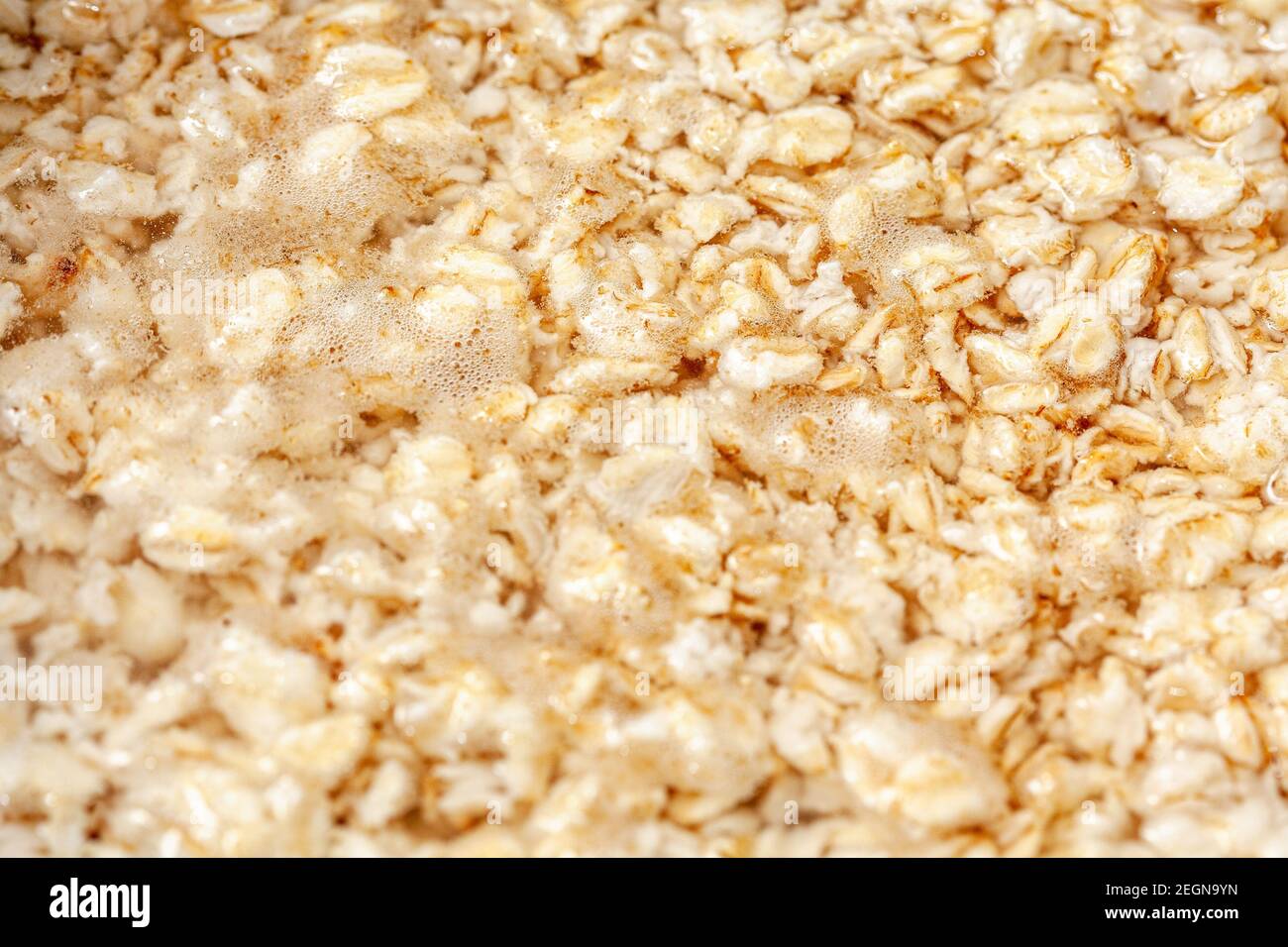 Oatmeal boiling , cereals preparation for breakfast Stock Photo - Alamy