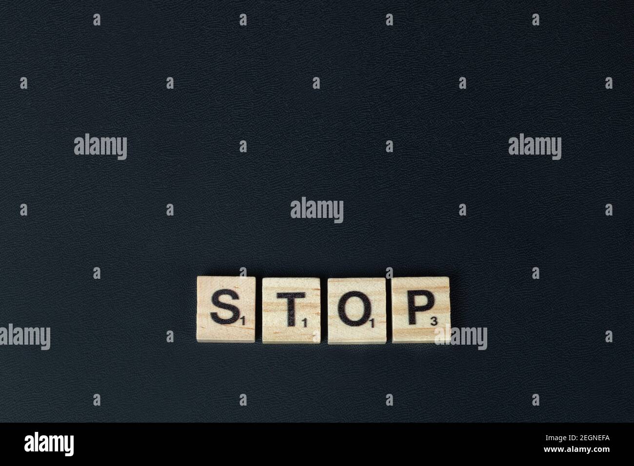 Stop symbolic writing with black letters on wooden dices in horizontal ...