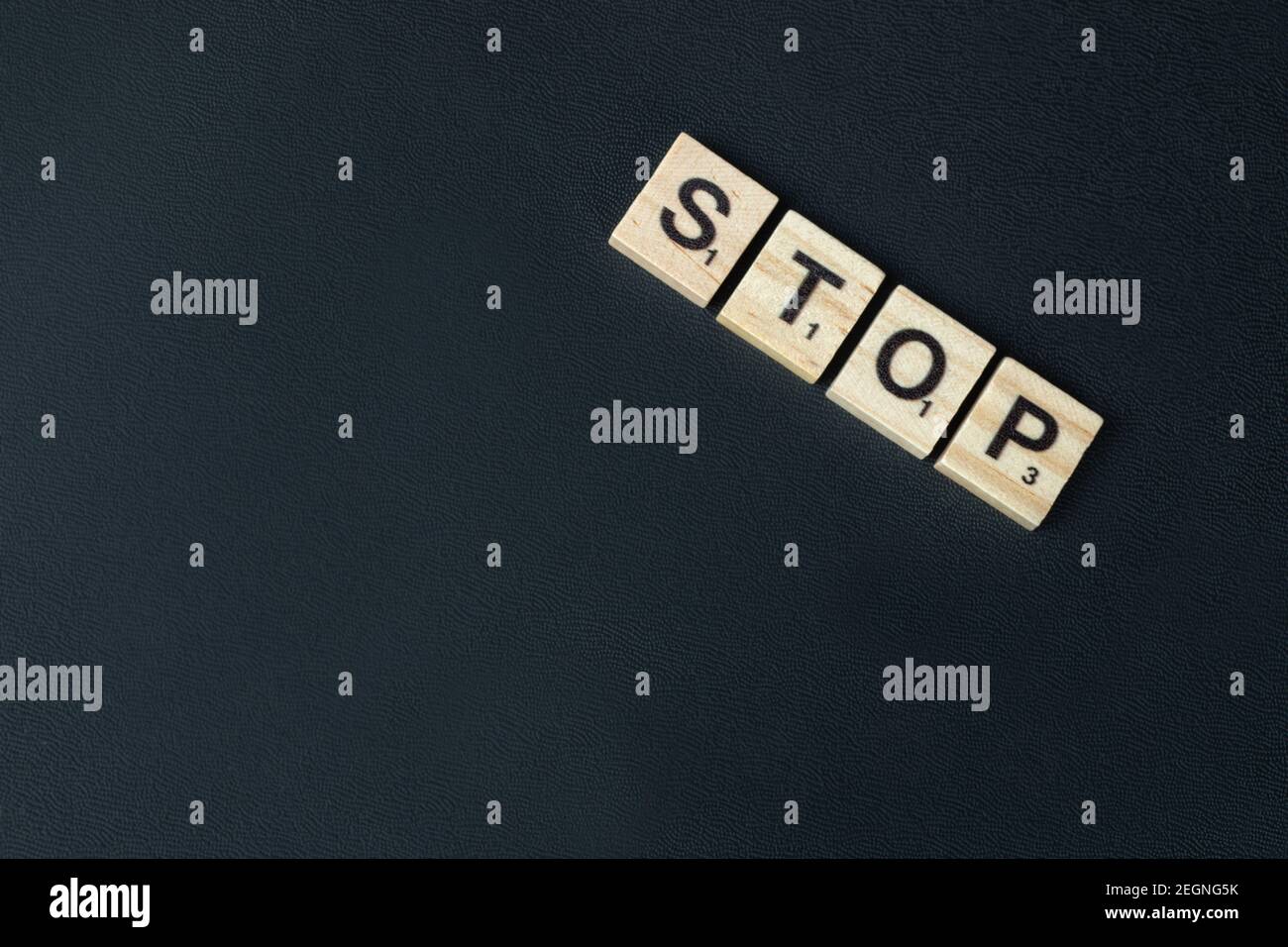 Stop symbolic writing with black letters on wooden dices in horizontal ...
