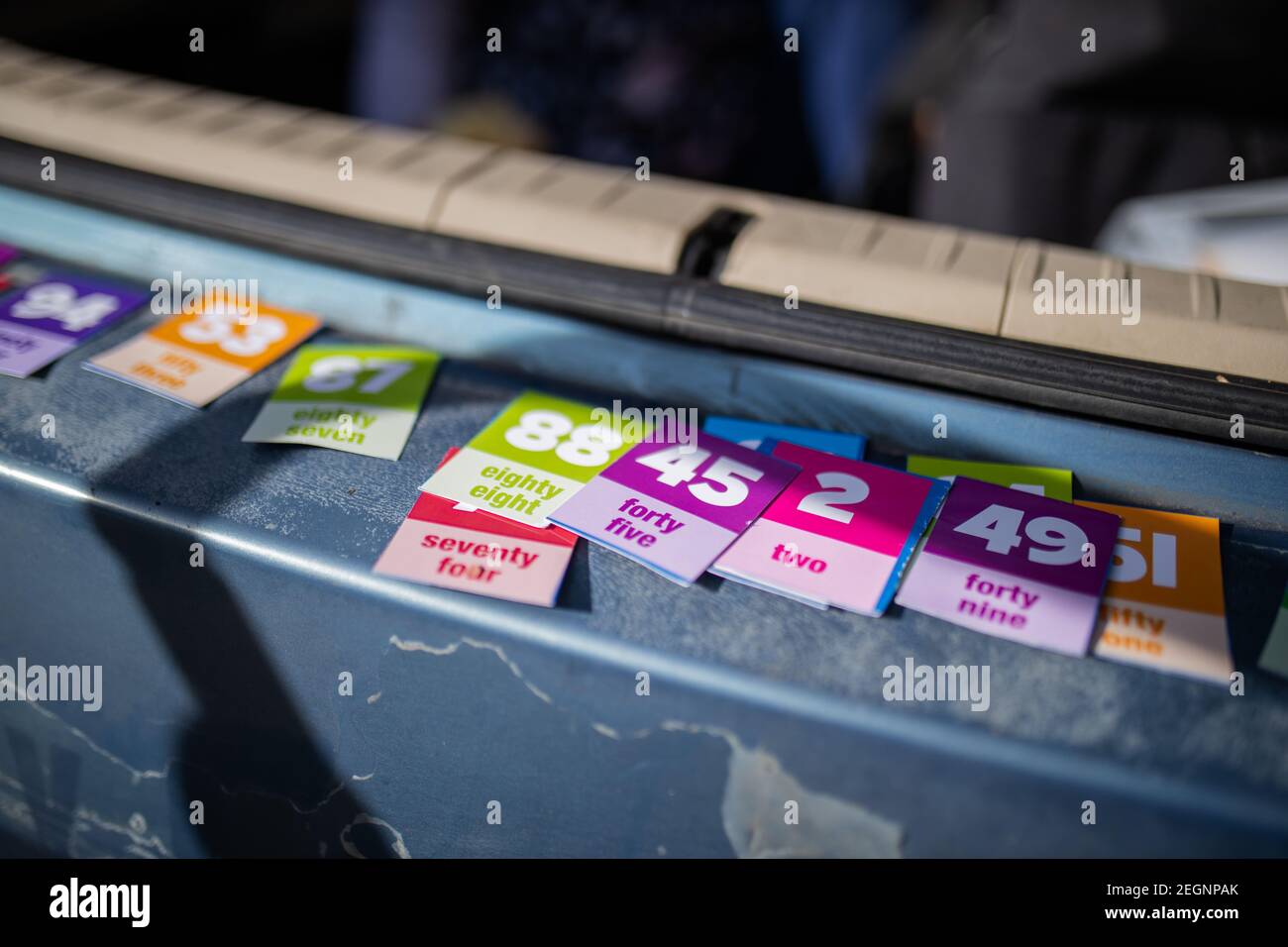 Colorful number cards on the blue bumper of a vehicle Stock Photo - Alamy