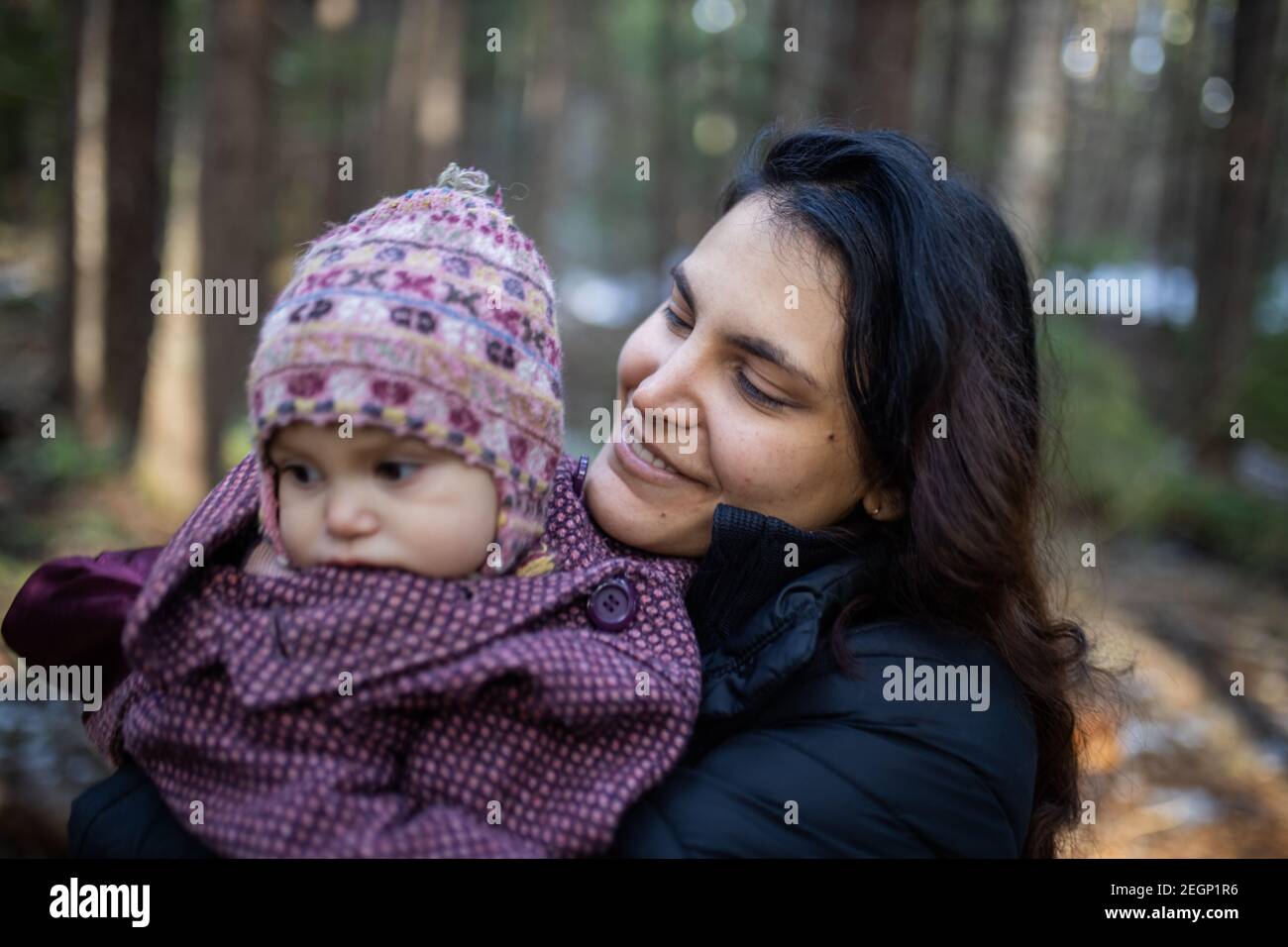 Happy woman holding her adorable baby in the forest Stock Photo - Alamy
