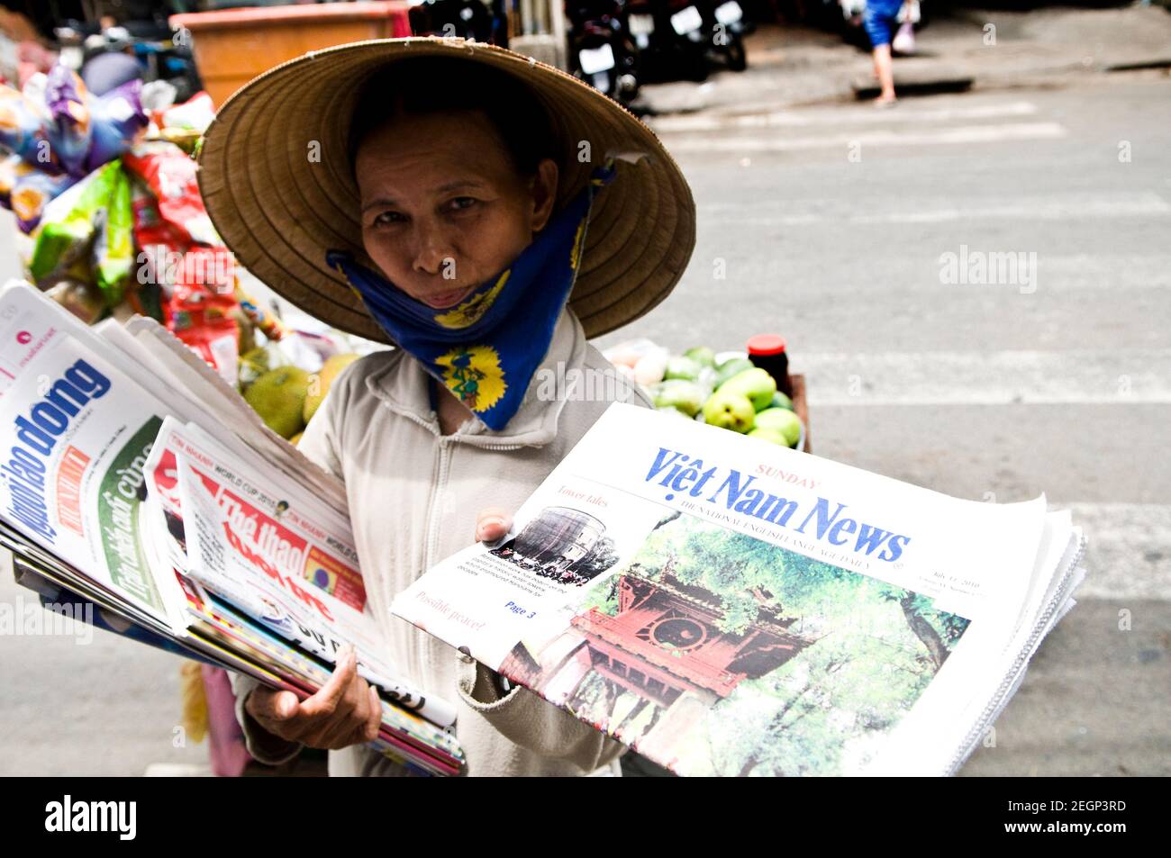 A Vietnamese woman selling newspapers in Ho Chi Minh city in Vietnam ...