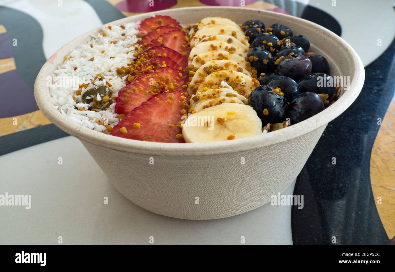 Acai bowl super food, shaved coconut, sliced strawberries, bananas and ...