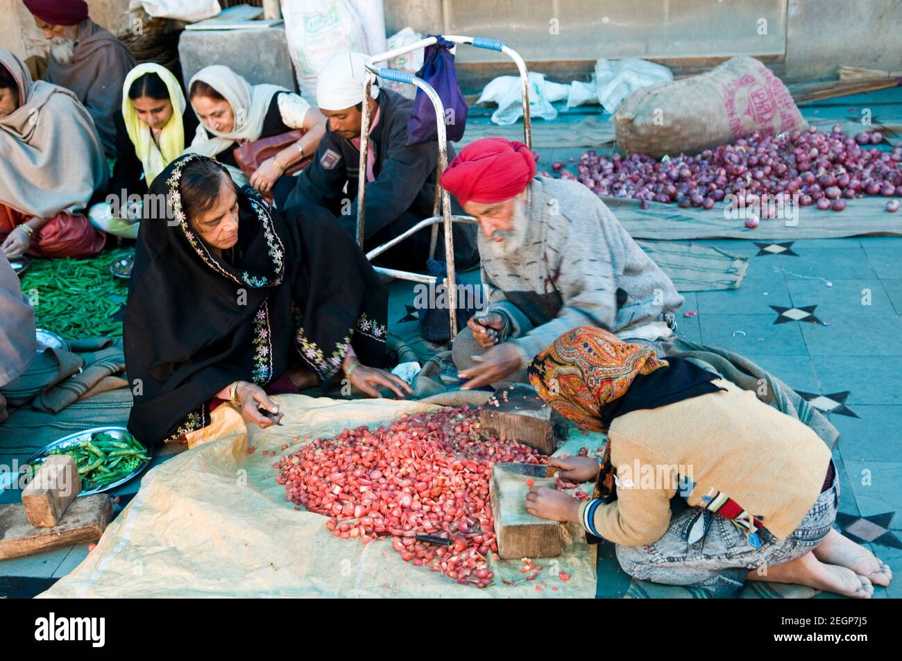 Sikh volunteers working in the kitchen of the Golden temple in Amritsar ...