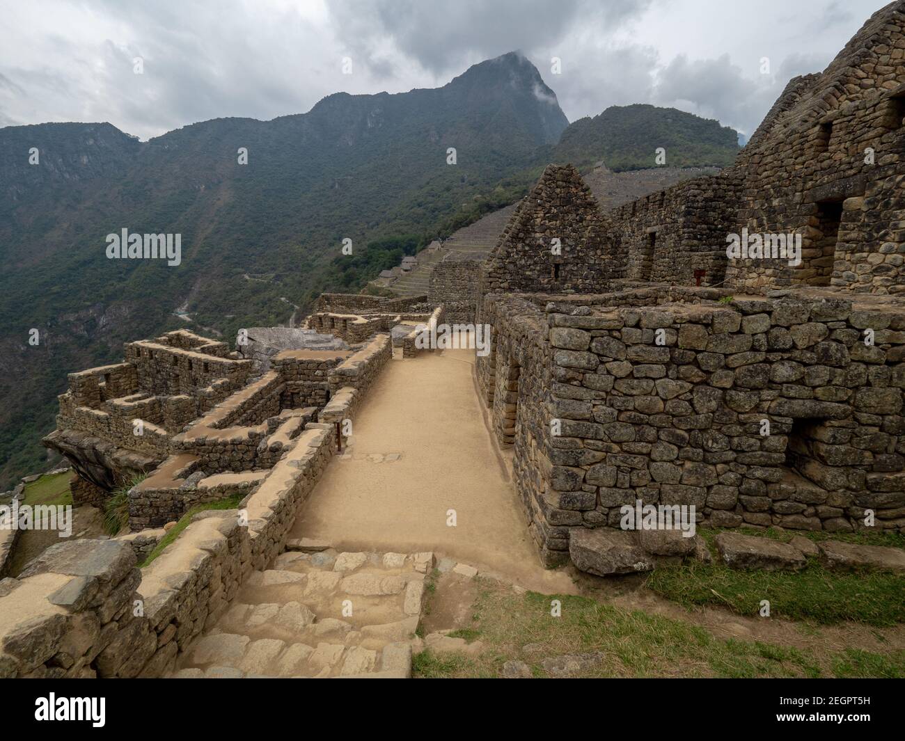 Stone walls at Machu Picchu citadel, mountain range in the background ...