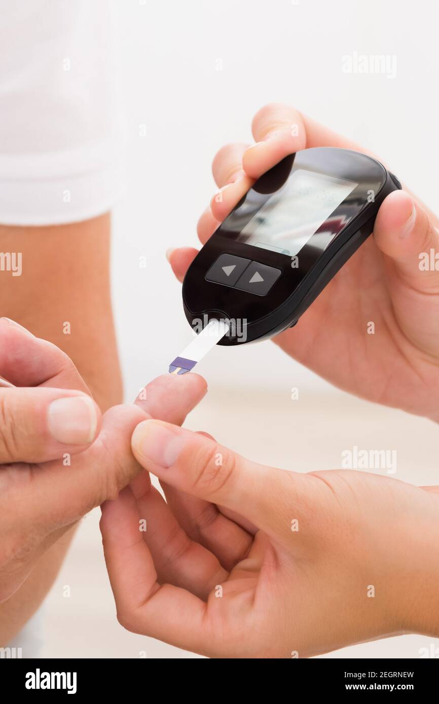 Male Patient At Doctor Checking Glucose Using Glucometer Monitor Stock ...