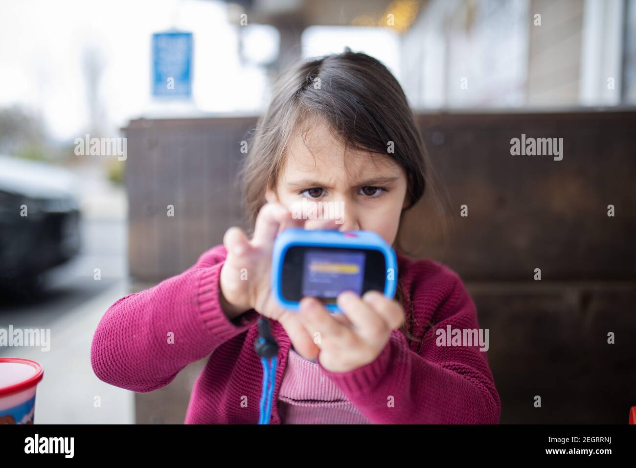 Little girl holding a small camera for kids Stock Photo - Alamy