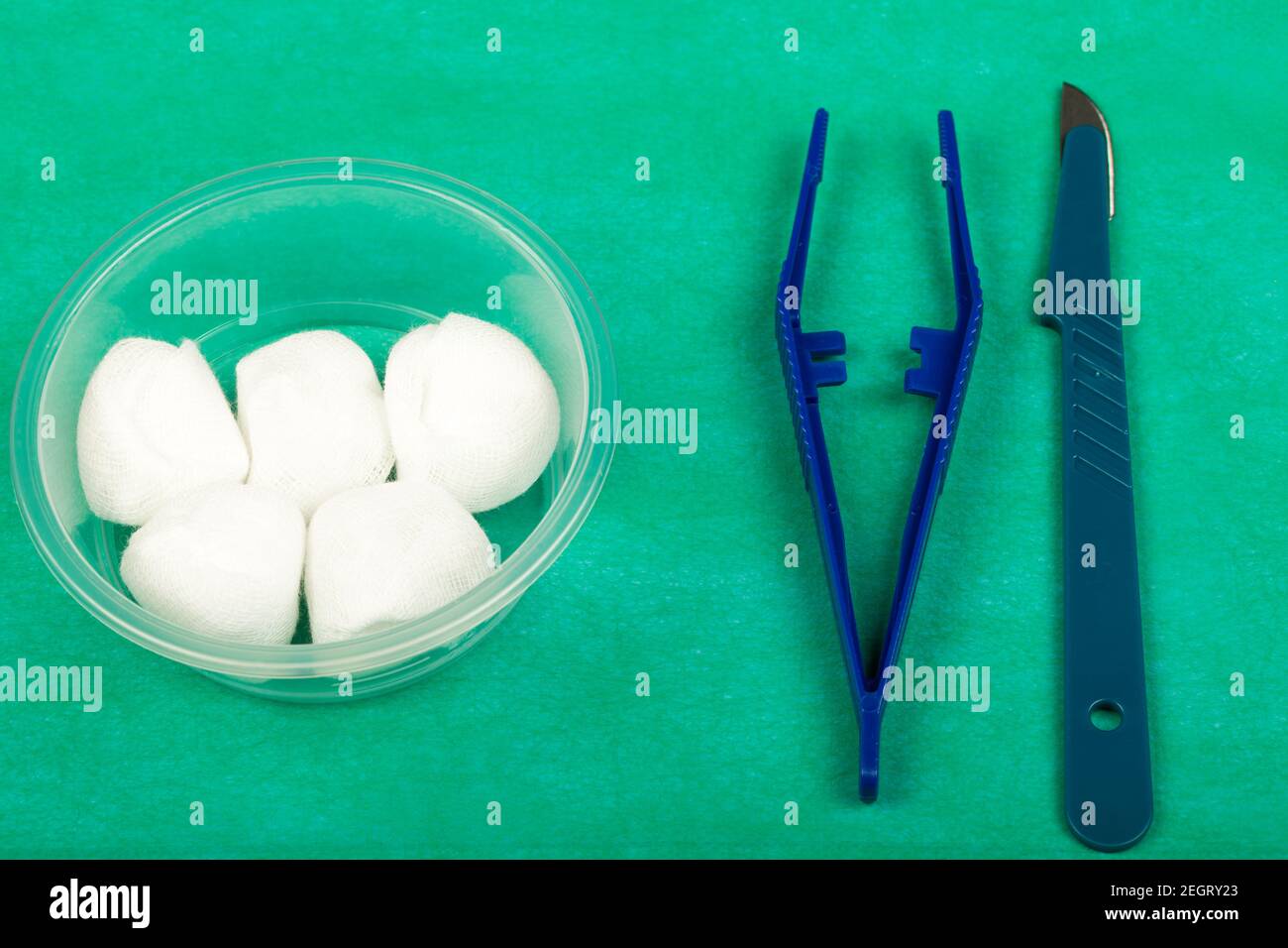 Plastic surgical instruments on a green background Stock Photo - Alamy