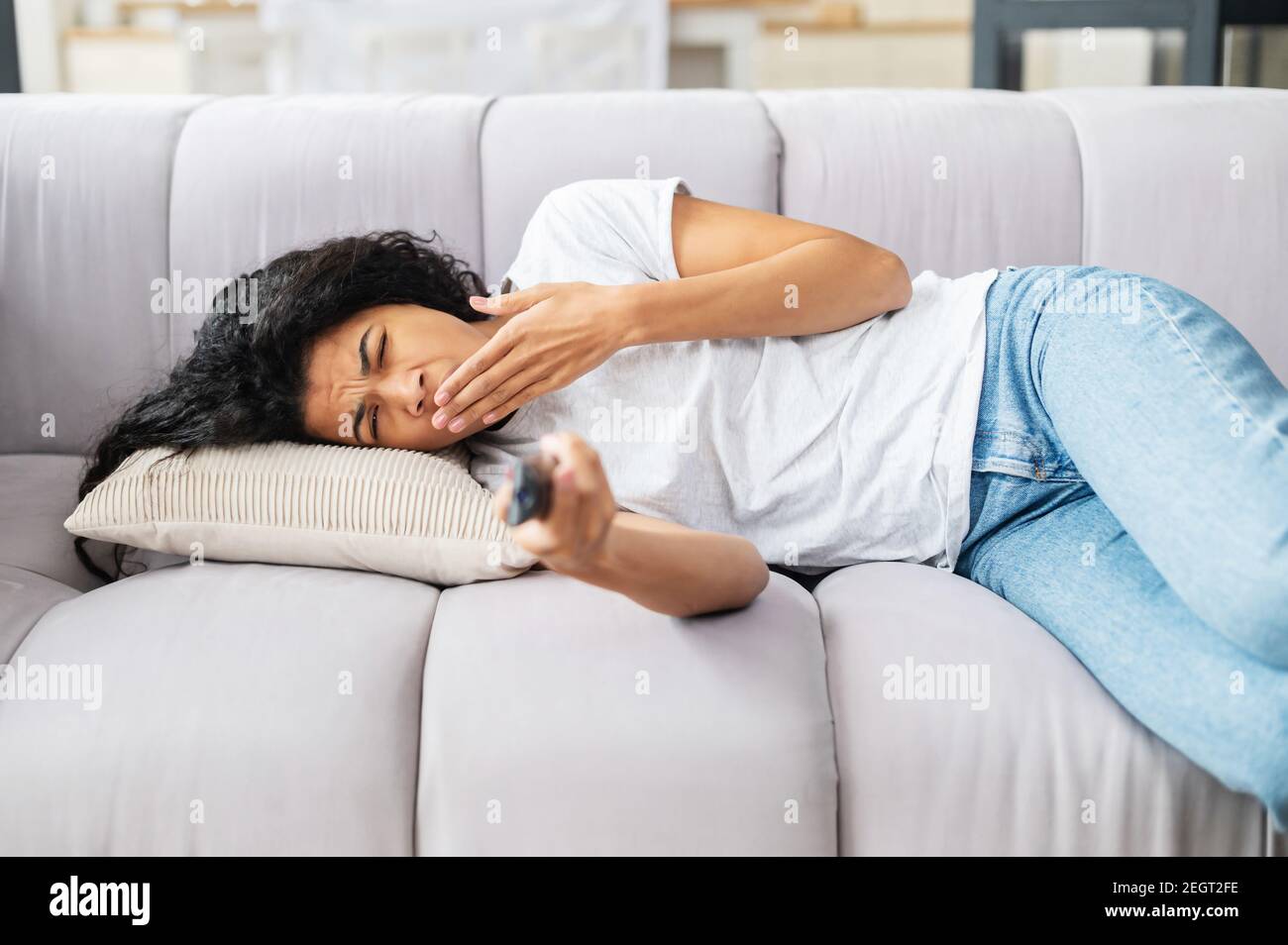 Bored girl lying on sofa hi-res stock photography and images - Alamy