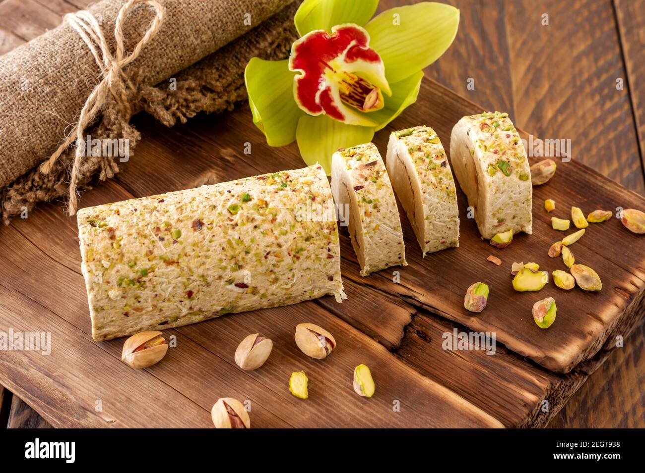 Oriental sweets - halva with pistachios served with orchid flowers ...
