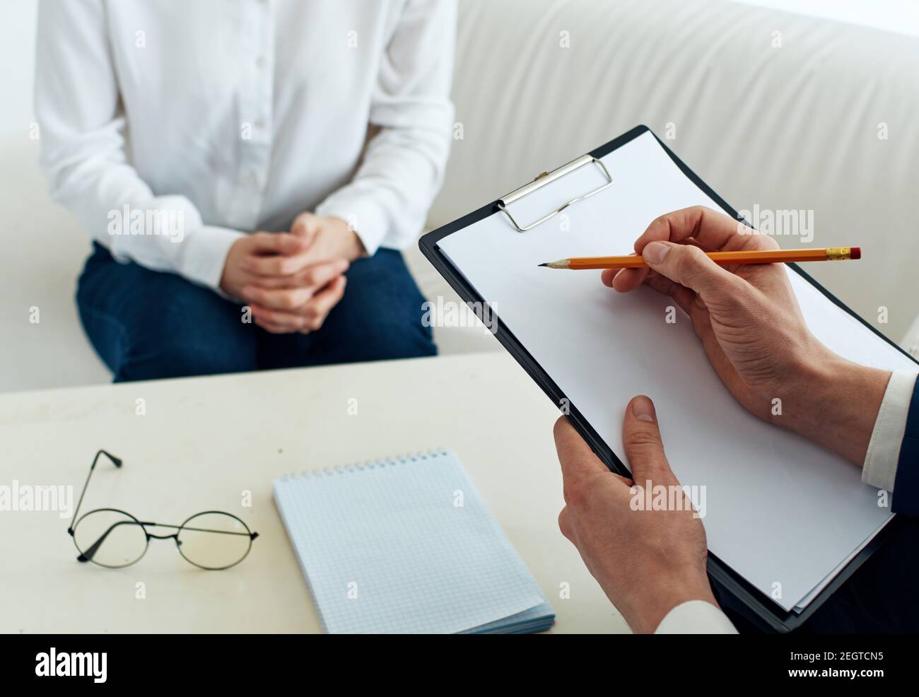 male psychologist with documents and woman indoors Stock Photo - Alamy