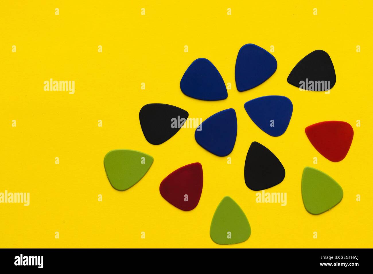 Guitar picks are placed on a yellow background Stock Photo - Alamy