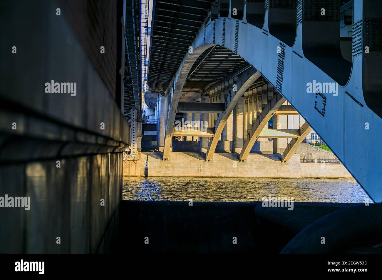 Powerful iron bridge structure, View from below. Concrete pillars, big ...